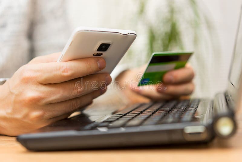 Young Man is Using Credit Card for Online Shopping on Smart Phone and ...