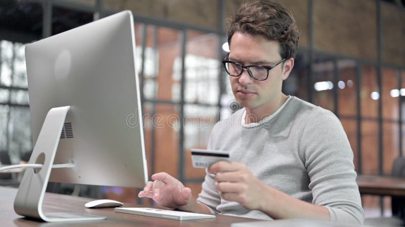 Young Man Using Credit Card for Payment on Computer Stock Image - Image ...