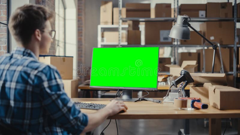 Young Man Using Desktop Computer with a Green Screen Chromakey Mock Up ...