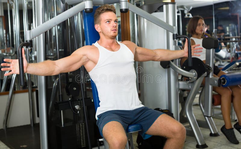 Young Man Using Fly Machine in Gym Stock Image - Image of exercise ...