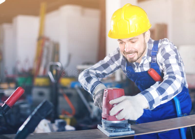 Young Man is Using Grinder for Construction Work Stock Image - Image of ...