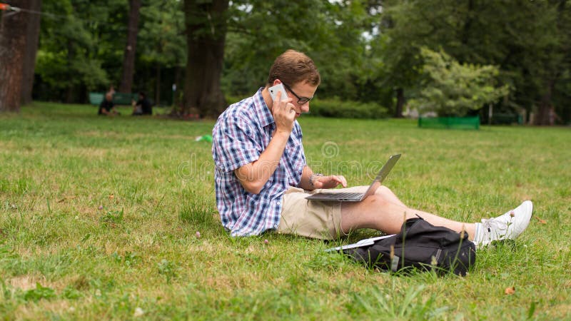 Young Man Using His Laptop on the Grass. Stock Image - Image of college ...