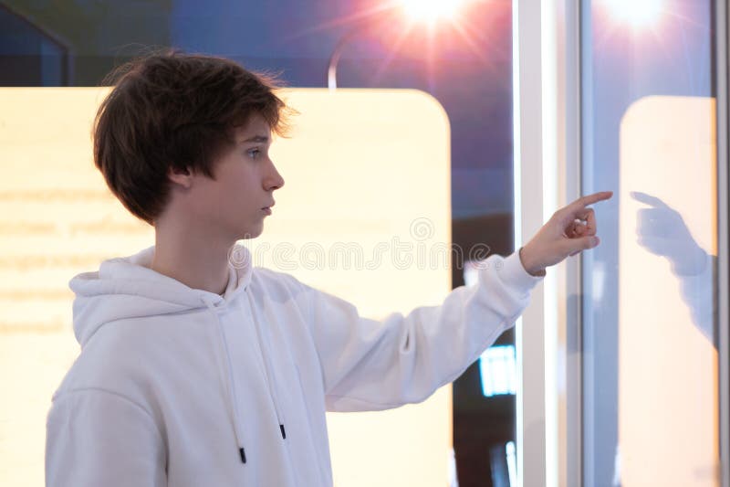Young Man Using Interactive Touchscreen Kiosk - Scrolling and Touching ...
