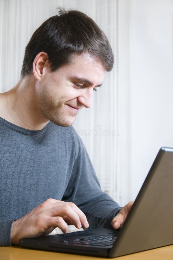 Young man using laptop stock image. Image of smiles, male - 23762595