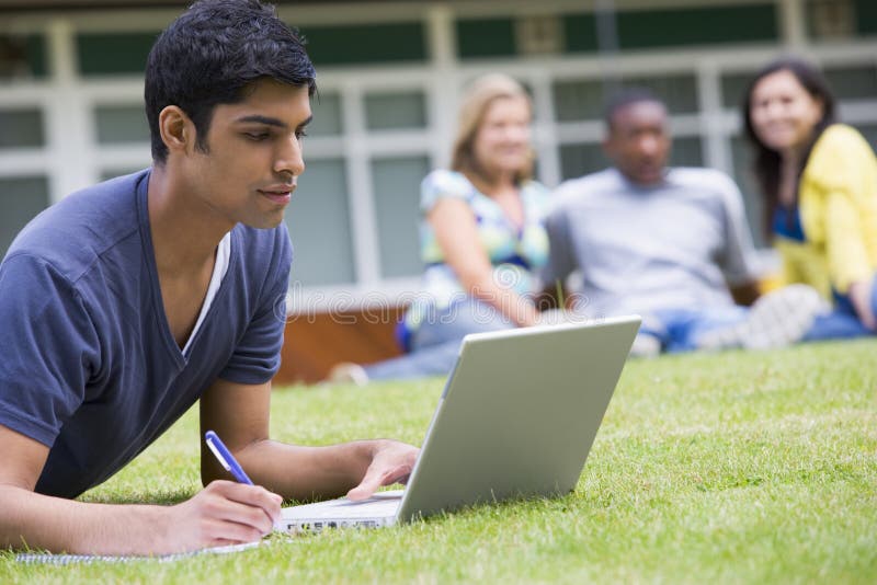 Two College Students Using Laptop on Campus Lawn, Stock Image - Image ...