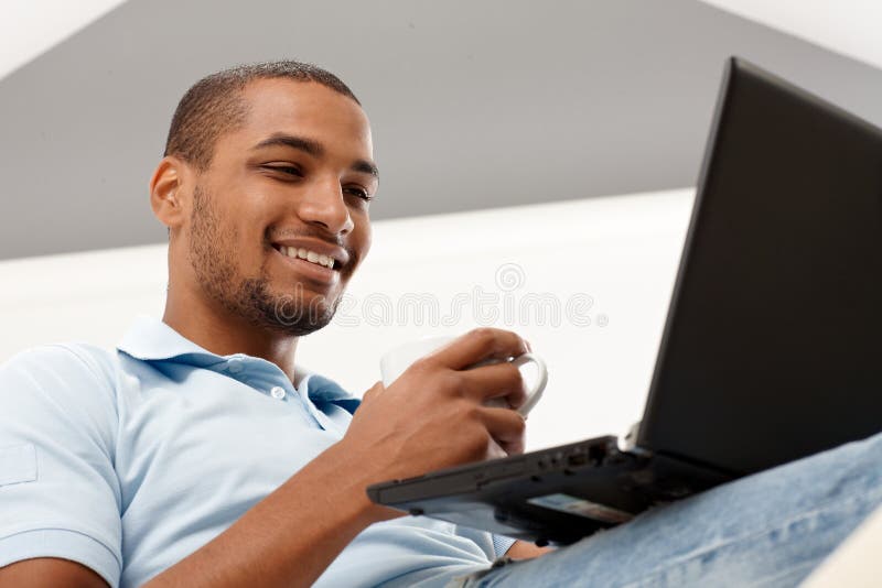 Young Man Using Laptop Computer Stock Photo - Image of concentrating ...