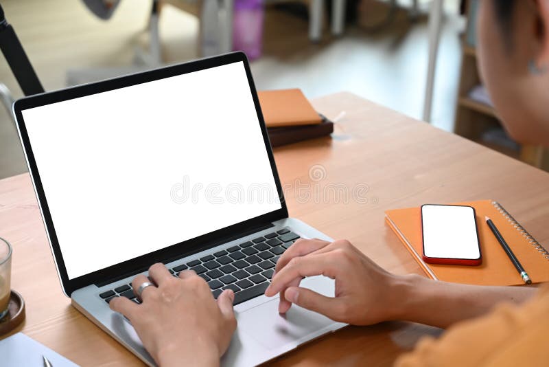 Young Man in Face Mask Talking on Mobile Pone and Using Laptop Computer ...