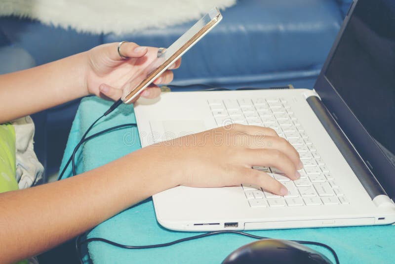 Young Man Using Laptop Computer and Mobile Smart Phone at Home Office ...
