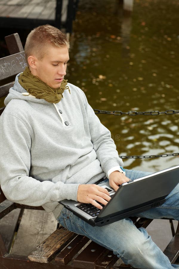 Young Man Using Laptop Computer Outdoors Stock Image - Image of ...