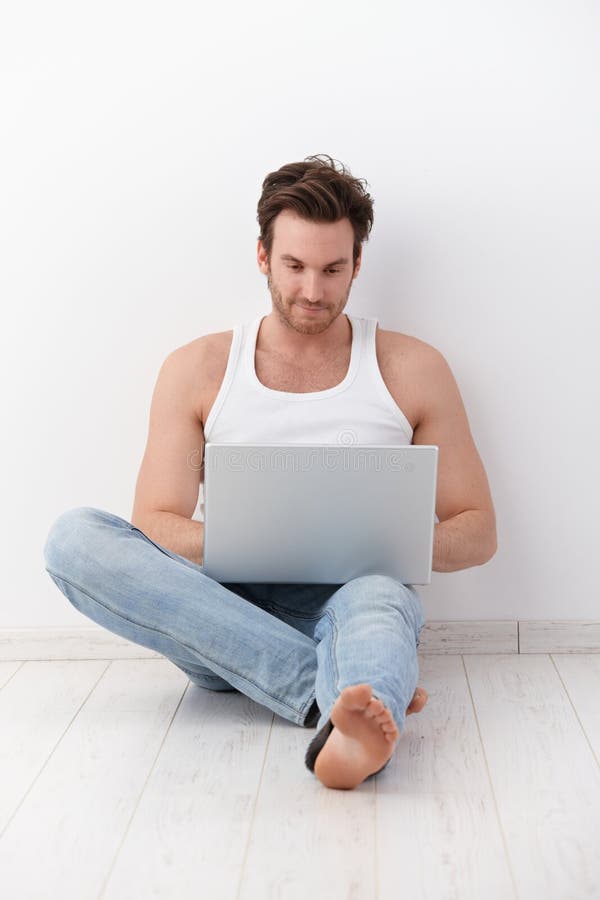 Young Man Using Laptop on Floor Smiling Stock Photo - Image of laptop ...