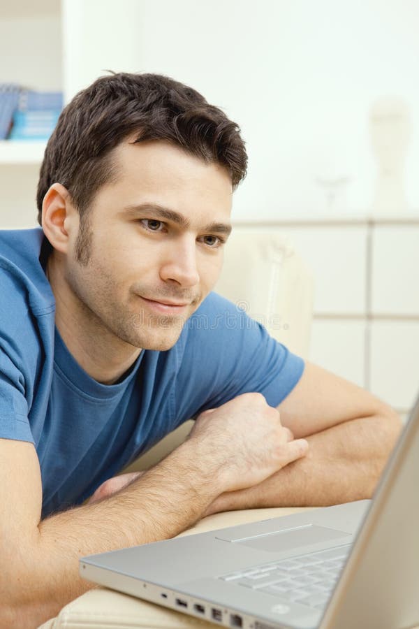 Young Man Using Laptop at Home Stock Image - Image of furniture, good ...
