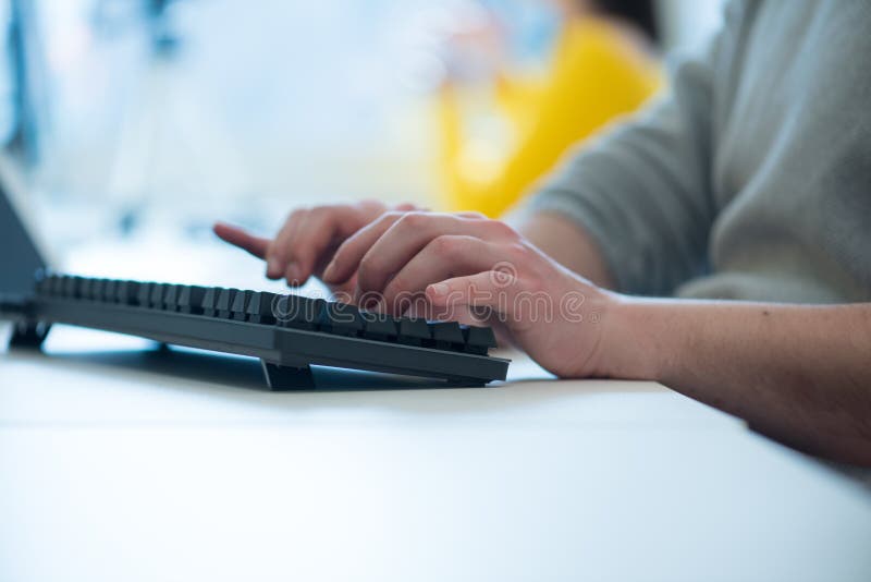 Young Man Using Laptop in Office, Typing on Keyboard. Writer ...