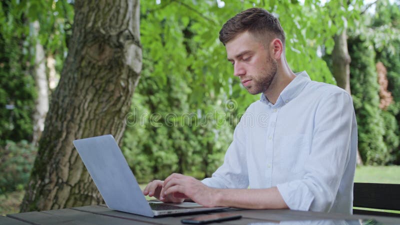 A Young Man Using a Laptop in the Park Stock Image - Image of ...
