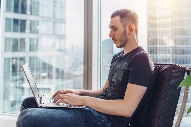 Young Man Using Laptop while Sitting on a Sofa Stock Image - Image of ...