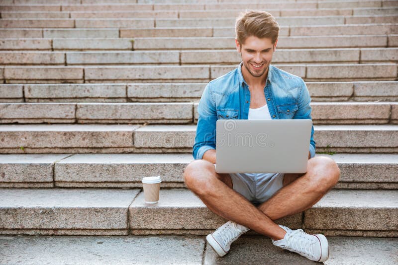 Young Man Using Laptop while Sitting on the Staircase Outdoors Stock ...