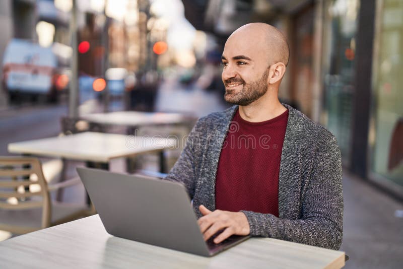 Young Man Using Laptop Sitting on Table at Coffee Shop Terrace Stock ...