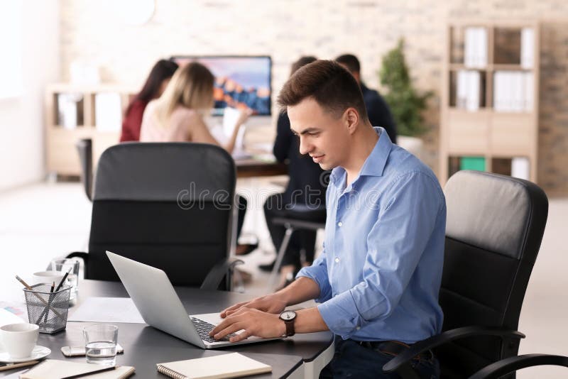 Young Man Using Laptop To Get Ready for Business Meeting in Office ...