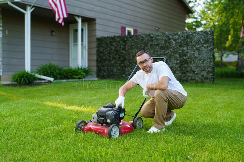 Young Man Using Lawn Mower Outdoor and Checking Oil Stock Photo - Image ...