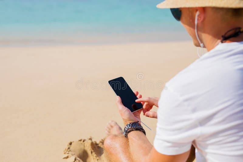 Young Man Using Mobile Phone on the Beach Stock Photo - Image of read ...