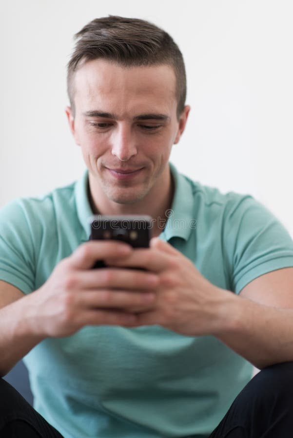 Young Man Using a Mobile Phone at Home Stock Photo - Image of relax ...