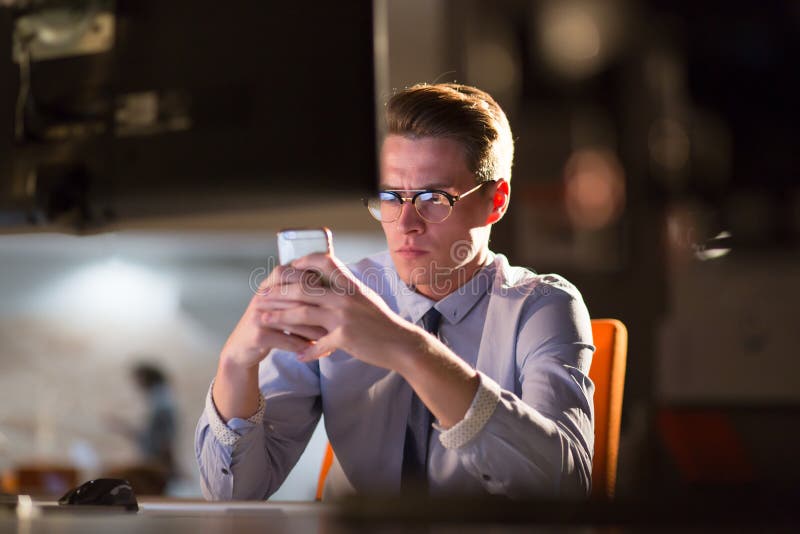 Man Using Mobile Phone in Dark Office Stock Photo - Image of ...