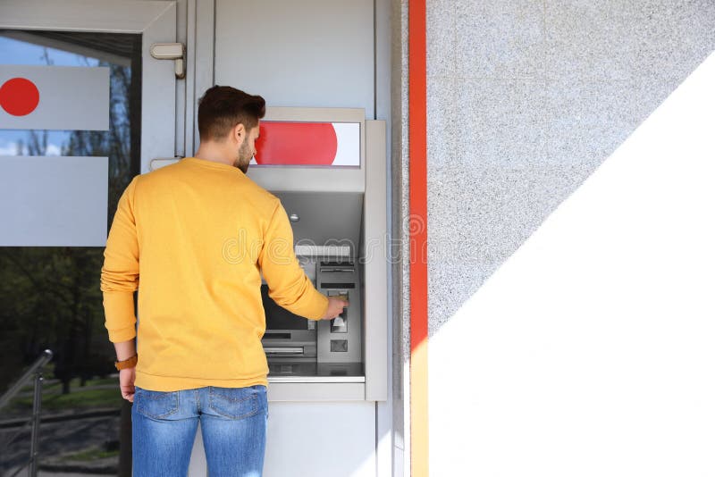 Young Man Using Modern Cash Machine Stock Photo - Image of currency ...