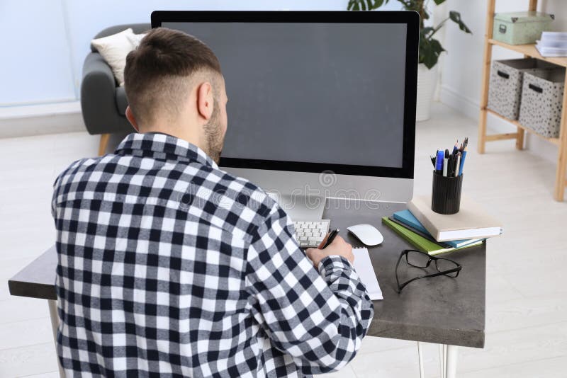 Young Man Using Modern Computer for Studying at Home, Back View ...