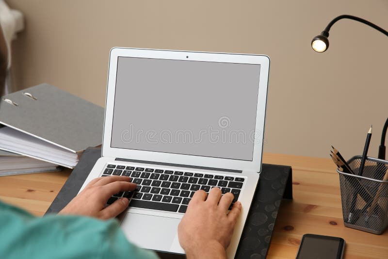 Young Man Using Modern Laptop at Table Stock Image - Image of indoors ...
