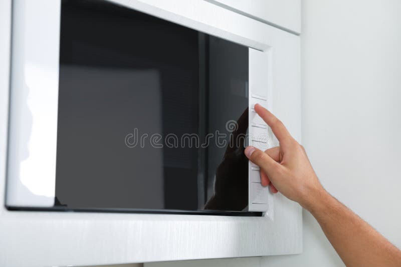 Young Man Using Modern Microwave Oven Stock Photo - Image of appliance ...