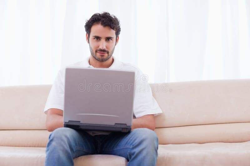 Young man using a notebook stock image. Image of internet - 22234215