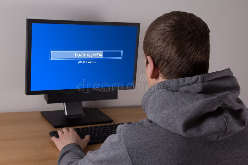 Young Man Using Personal Computer Loading at Home Stock Image - Image ...