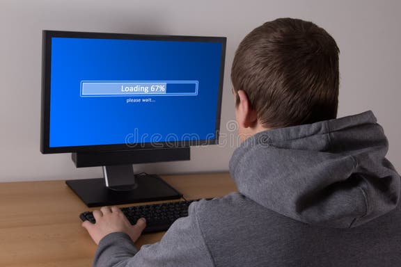 Young Man Using Personal Computer Loading at Home Stock Image - Image ...