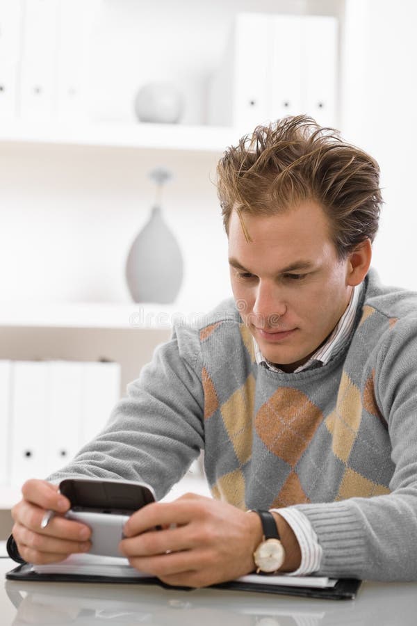 Young man using phone stock image. Image of chatting, european - 7690029