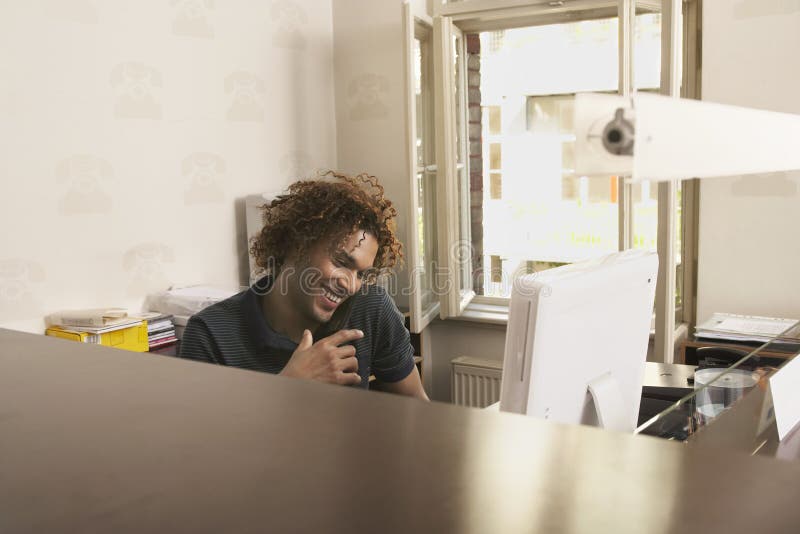 Young Man Using Phone in Office Stock Image - Image of indoors, phone ...