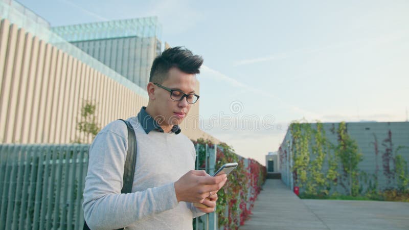 A Young Man Using a Phone Outside Stock Image - Image of summer, person ...