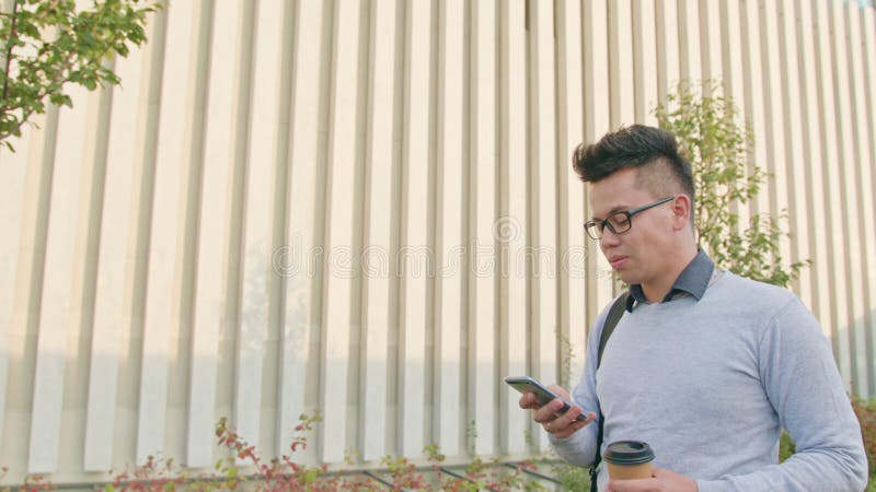 A Young Man Using a Phone Outside Stock Photo - Image of relaxing, male ...