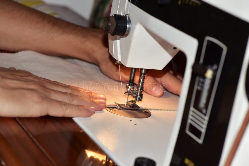 Young Man Using a Sewing Machine Stock Photo - Image of machine ...
