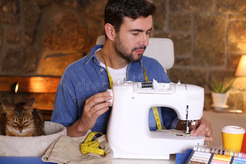 Young Man Using Sewing Machine Stock Photo - Image of designing, cute ...