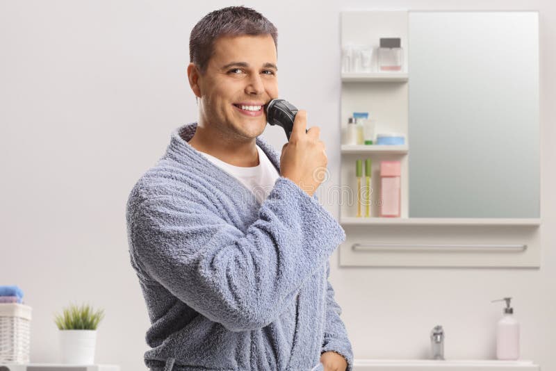 Young Man Using a Shaving Machine in a Bathroom Stock Image - Image of ...