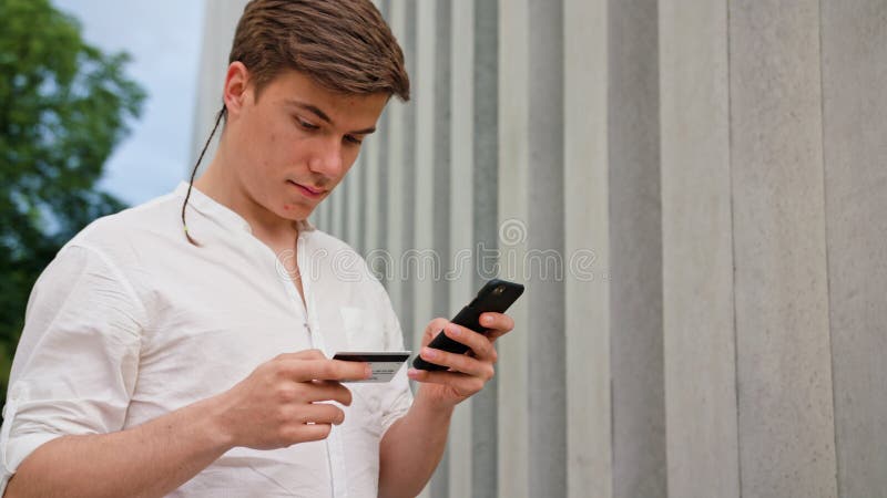 A Man Using a Mobile Phone Outdoors Stock Photo - Image of male, light ...