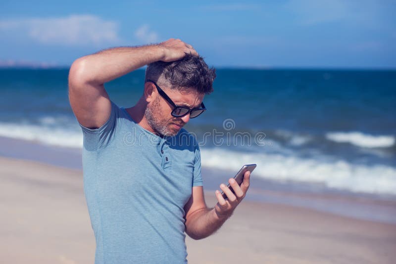 Young Man Using Smartphone on the Beach Stock Image - Image of outside ...