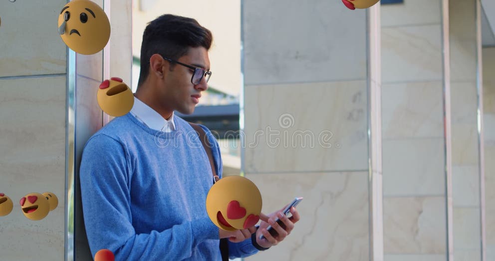 Young Man Using Smartphone Outdoors Surrounded by Floating Emojis ...