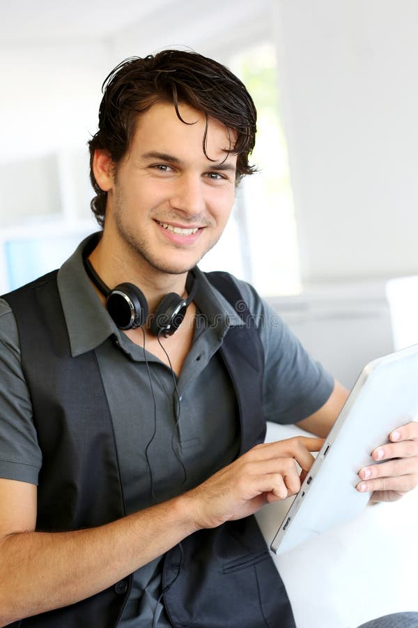 Young man using tablet stock photo. Image of cheerful - 26668440