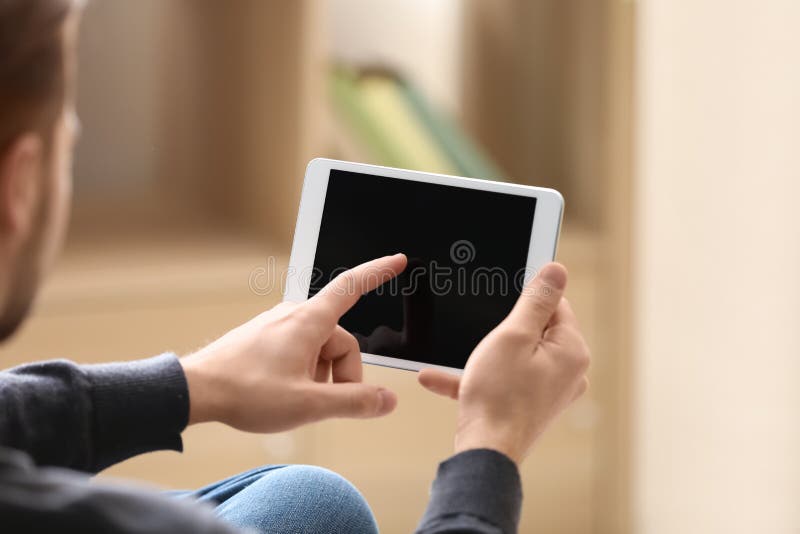 Young Man Using Tablet at Home Stock Photo - Image of application ...