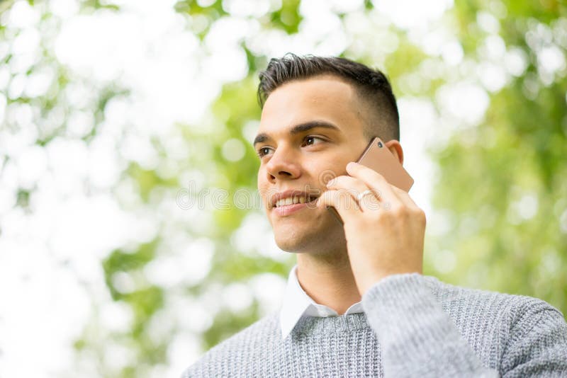 Young Man Using Tablet & Mobile Phone in the Park Stock Image - Image ...