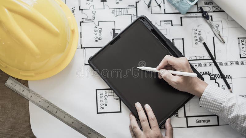Young Man Using Tablet Plotting a System of Building Structures in ...
