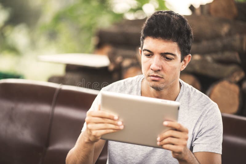 Young man using tablet stock photo. Image of people, woods - 49510588