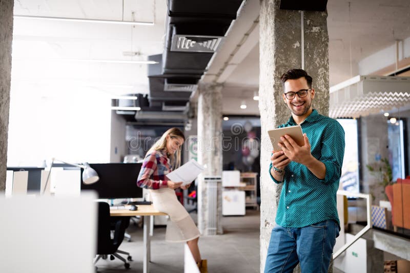 Young Man Using Technology, Digital Tablet in Corporate Business Office ...