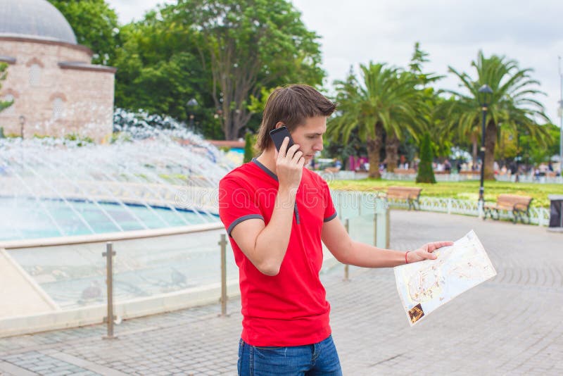 Young Man Using Telephone with Map in Hands Stock Image - Image of ...