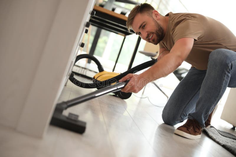 Young Man Using Vacuum Cleaner at Home Stock Photo - Image of dusty ...